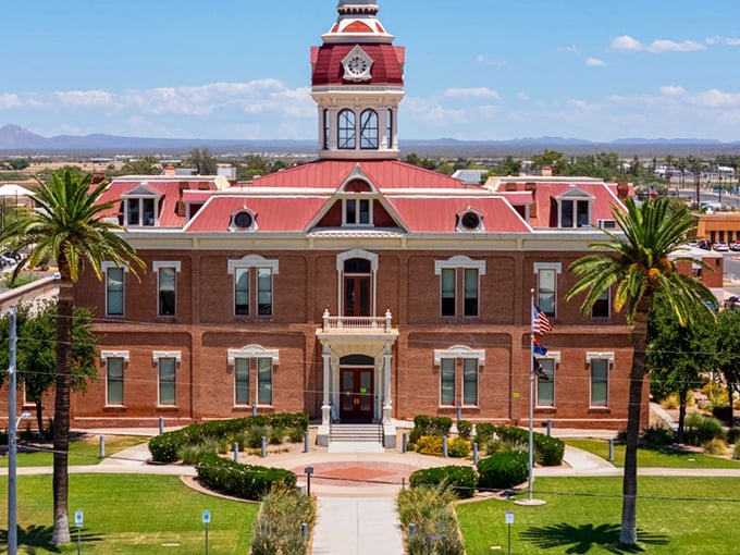 The Pinal County Courthouse stands as Florence's crown jewel, its brick fa&ccedil;ade and palm sentinels creating a postcard-perfect scene.