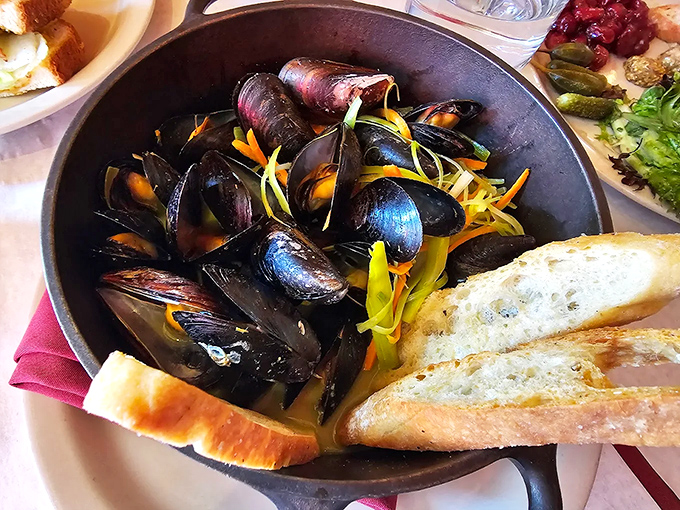 Curried coconut mussels swimming in aromatic broth, because sometimes the best French bistros know when to take a delicious detour through other flavors.