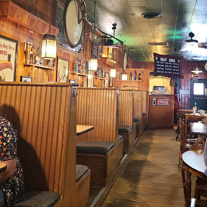 Cozy booths lined with wood paneling create intimate dining spaces where memories are made between bites of legendary burgers.
