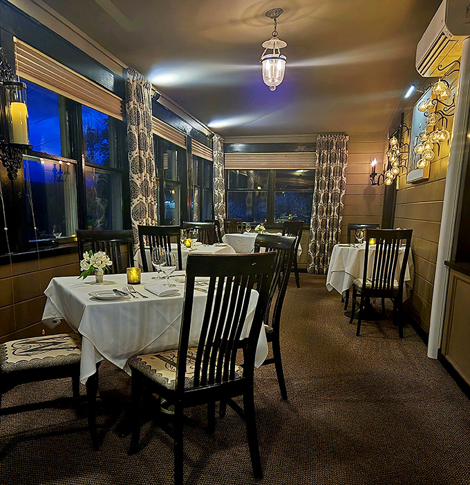 Evening transforms the dining area into an intimate retreat &ndash; soft lighting and white tablecloths setting the stage for culinary magic.
