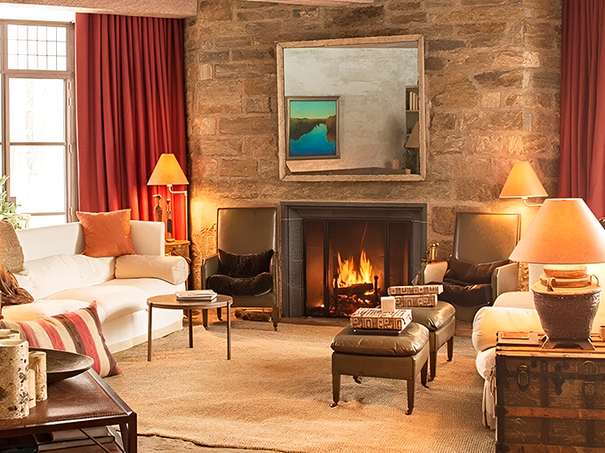 Warm orange lampshades cast a sunset glow across this living room, where comfort and sophistication coexist beautifully.