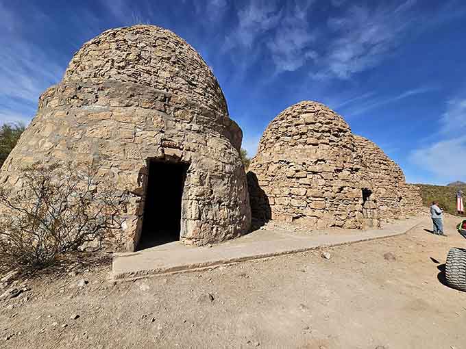 The weathered facade shows over a century of desert sun and wind, yet these structures refuse to surrender to time.