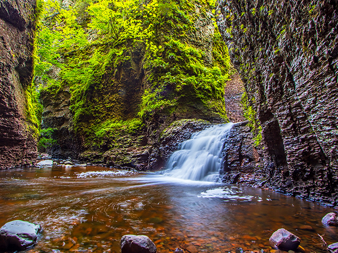 Kadunce River carves through ancient rock, creating a slot canyon hike where the trail becomes the stream and wet feet are guaranteed.