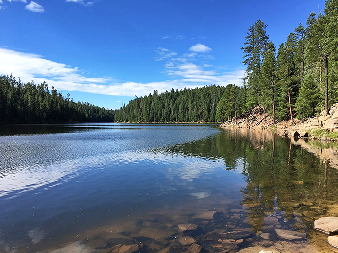 Woods Canyon Lake offers perfect reflections and peaceful fishing spots, a serene oasis nestled among towering pines.