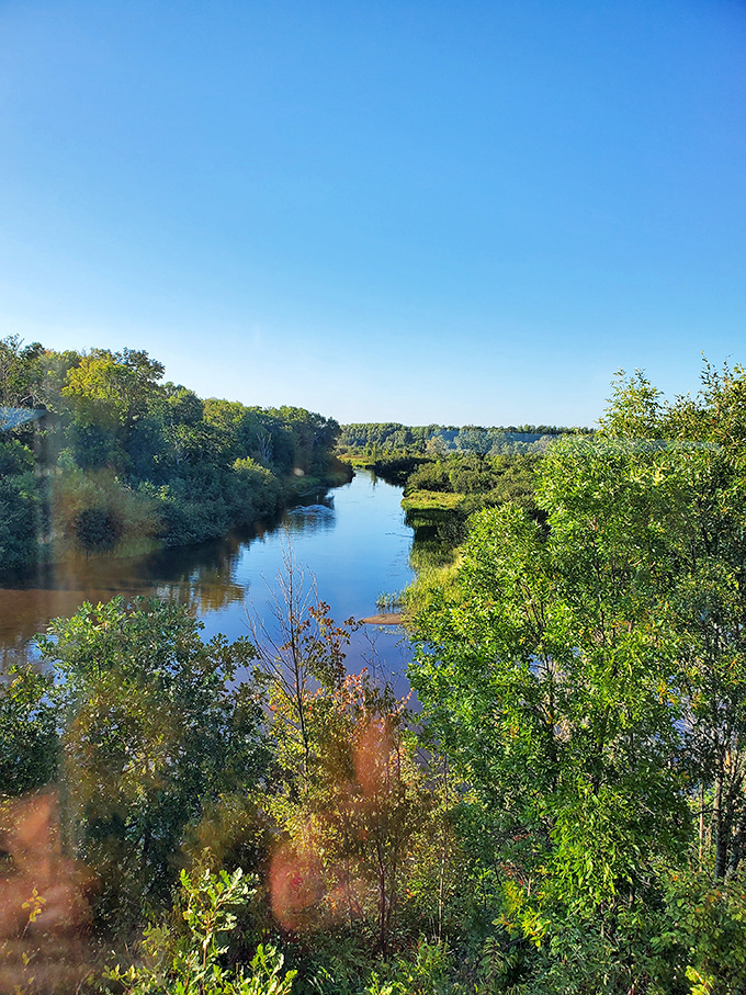 The train offers front-row seats to Wisconsin's natural splendor, where rivers carve gentle paths through verdant wilderness.