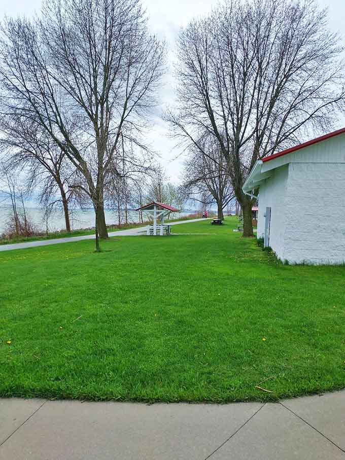 Simple white buildings and towering trees create a peaceful rest area &ndash; the trail's version of a lakeside living room.