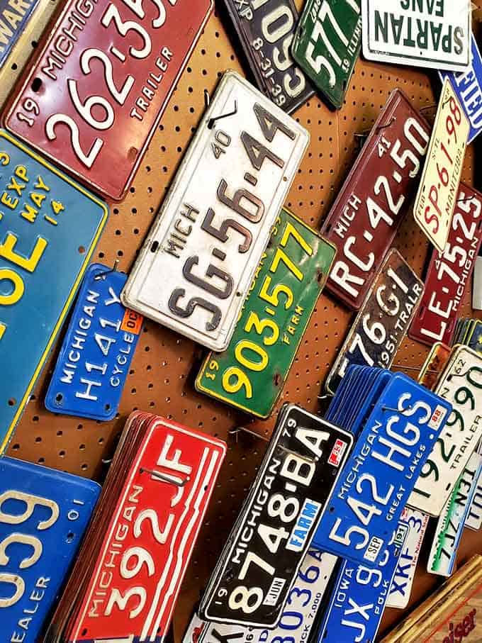 License plates from across America create a colorful mosaic of road trips past, each one a rectangular time capsule of automotive history.
