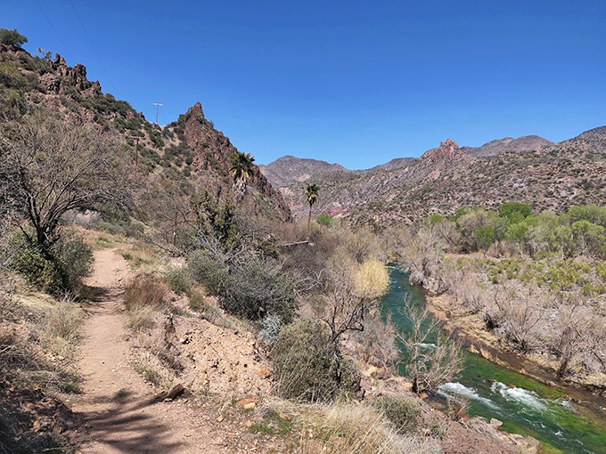 The trail follows the Verde River's meandering path, offering glimpses of what awaits at journey's end.