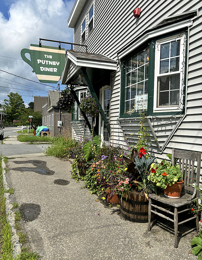 The Putney Diner's welcoming facade and flower-lined entrance promise comfort food and friendly conversation inside.
