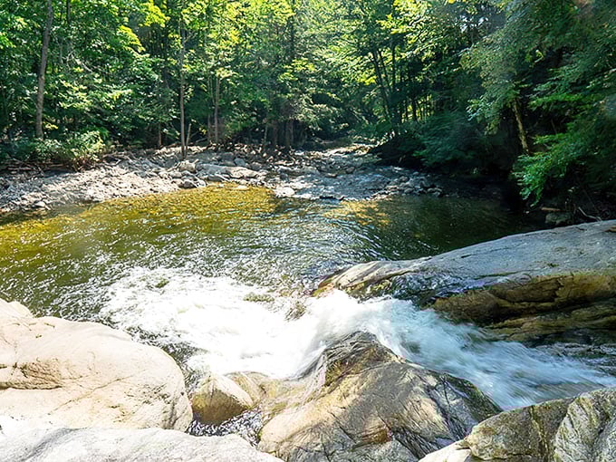 Autumn's golden touch: fall foliage reflects in crystal waters, creating a double display of Vermont's most celebrated seasonal show.