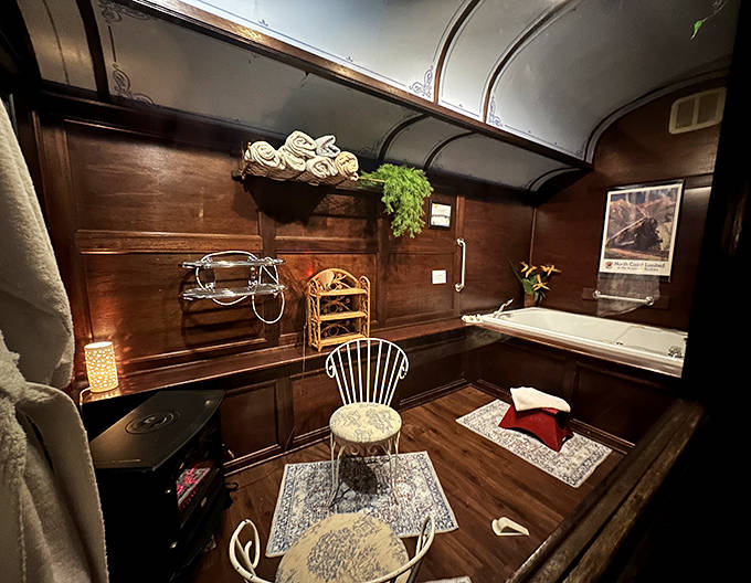 Indulge in a long soak in this deep whirlpool tub, surrounded by rich wood paneling and warm, flickering stove light.