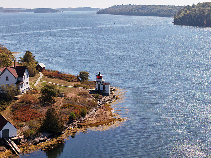 From above, the lighthouse and keeper's house form a perfect maritime tableau against the mighty Kennebec's flowing waters.