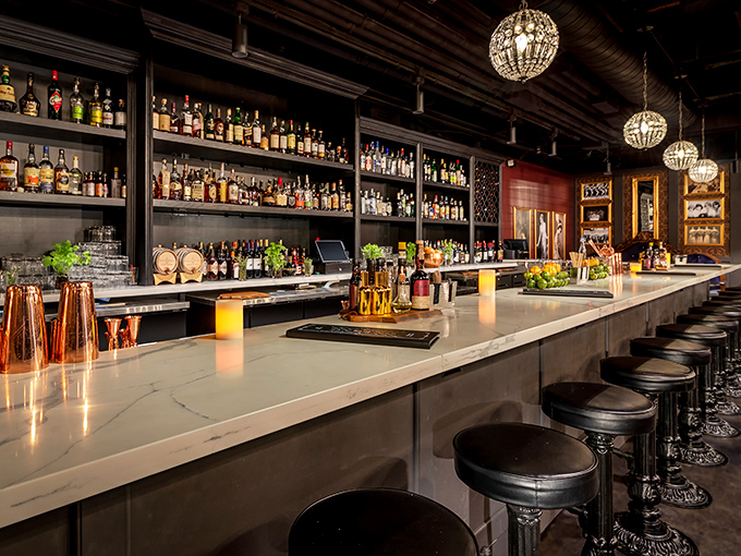 The White Rabbit's elegant bar stretches beneath carefully curated bottles, promising adventures in taste for those who appreciate fine spirits.