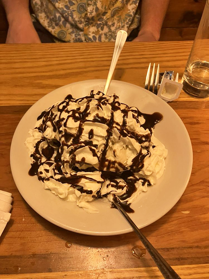A mountain of whipped cream drizzled with chocolate sauce &ndash; desserts here don't believe in moderation, and that's exactly as it should be.