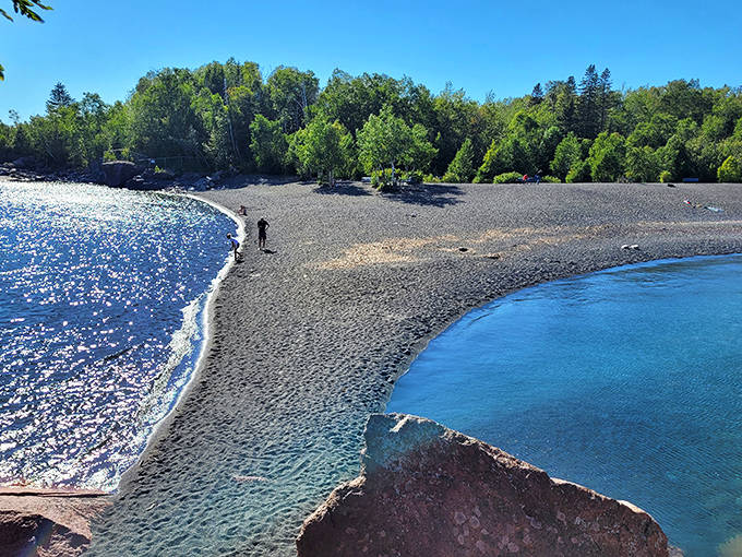 The North Shore's most photogenic stretch offers endless compositions where blue water meets black sand.