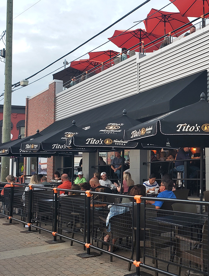 Happy patrons gather under Tito's umbrellas, plotting their strategy for the nachos while enjoying Michigan's fleeting but glorious summer weather.
