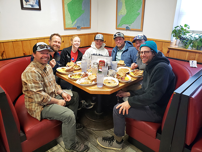Happy diners gathered around a table laden with Maine's finest comfort food, creating memories one bite at a time.