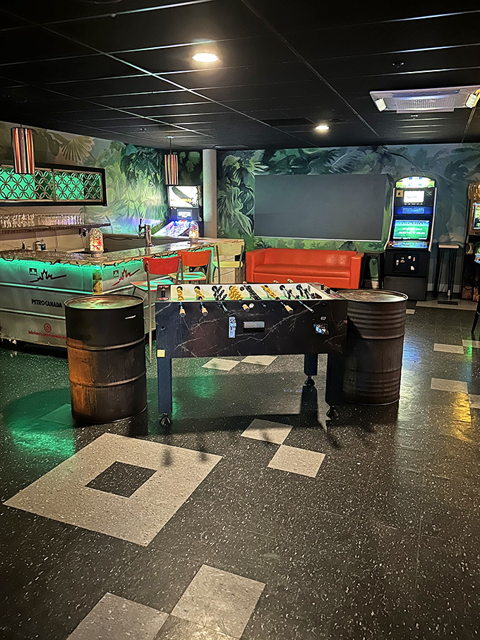 A foosball table flanked by barrel seats invites friendly trash-talking in this jungle-themed gaming nook &ndash; spin those handles with conviction!