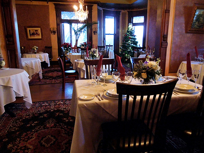 The dining room dressed for a special occasion, with tables awaiting guests who'll soon create memories as lasting as the castle itself.