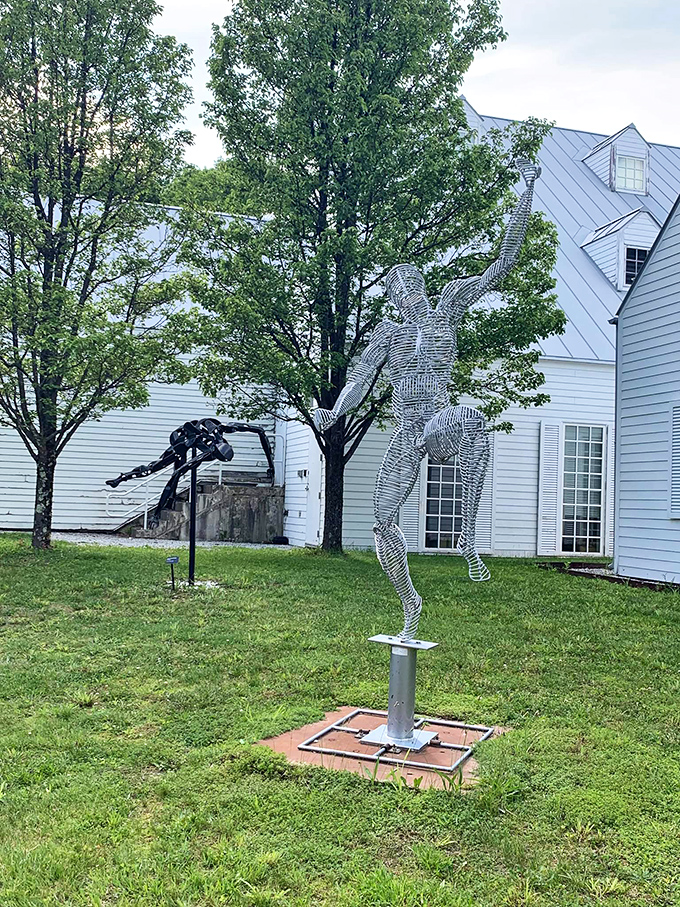 The white buildings of the arts center provide a striking backdrop for the outdoor sculpture garden's modern installations.