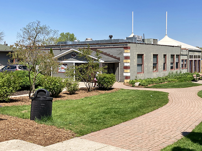 The restaurant's exterior blends seamlessly with its natural surroundings, looking as though it grew organically from the lakeshore itself.