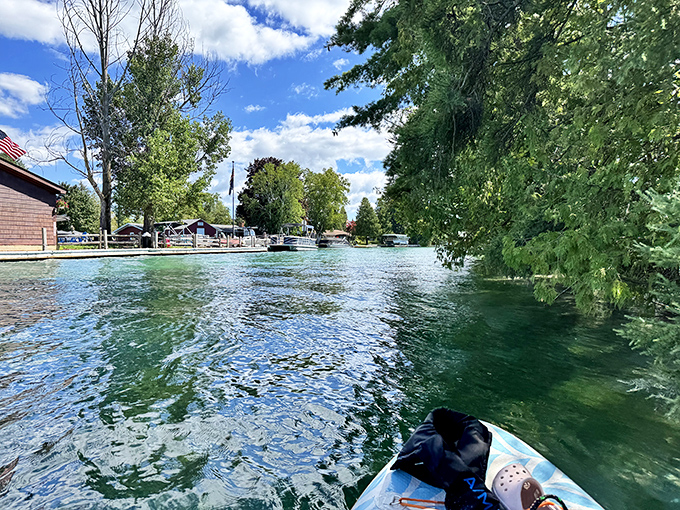 Gliding across nature's mirror &ndash; paddleboarding on Torch Lake offers the surreal sensation of floating above an underwater world in perfect clarity.