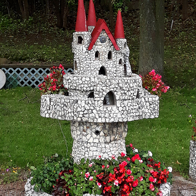 White stone and crimson accents make this castle particularly photogenic, especially when surrounded by carefully tended flowers.