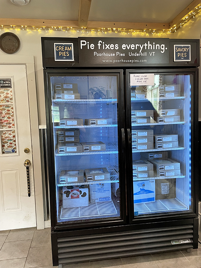 The refrigerated display case glows like a treasure chest, each shelf lined with boxed pies waiting for their forever homes.