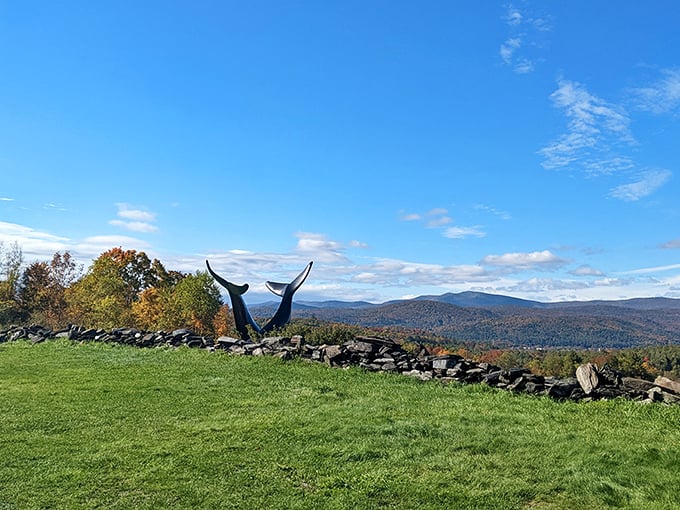 Vermont&rsquo;s rolling hills stretch beyond the stone wall, with the Whales Tails emerging as a striking hillside surprise.