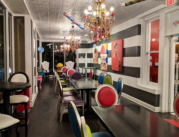 Colorful chairs line striped walls, creating a dining space that feels like you've fallen into the most delicious children's book.