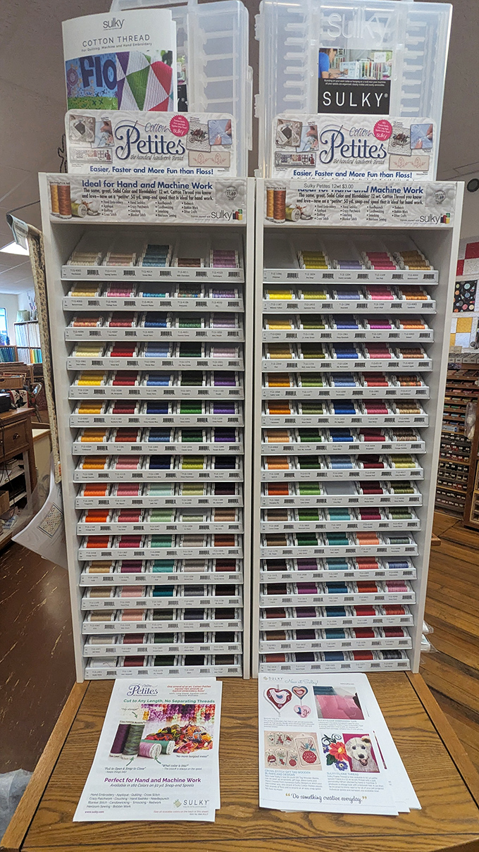 The thread display stands like a color wheel of possibilities, offering every shade needed to complement your fabric choices or add contrasting pops.