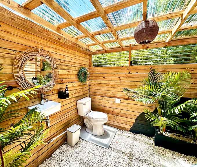 A bathroom so charming you might actually enjoy your morning routine, surrounded by plants and natural light.