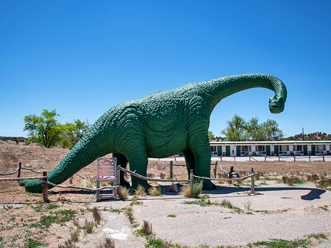 A friendly dinosaur stands guard outside the caverns, a playful nod to the prehistoric wonders waiting below.