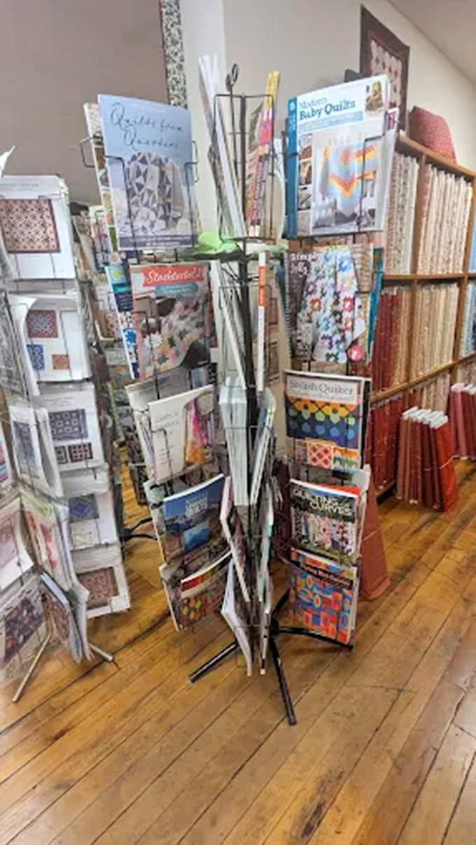 Pattern paradise! This rotating display of quilting magazines and designs serves as the shop's ever-changing menu of creative possibilities.