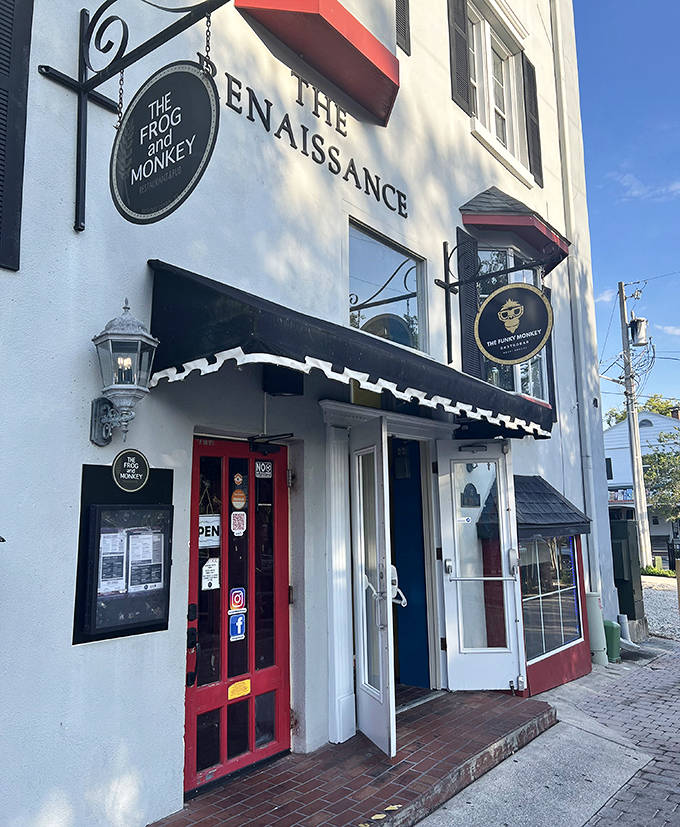 The Frog and Monkey's distinctive red door serves as a portal to pub perfection, where British comfort food meets Florida hospitality.