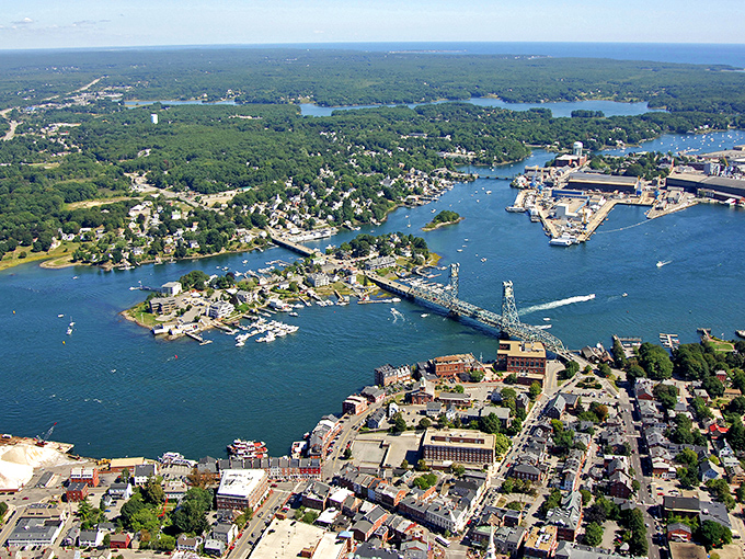 Kittery Point's harbor view captures the essence of coastal Maine, with bridges spanning blue waters under dramatic skies.