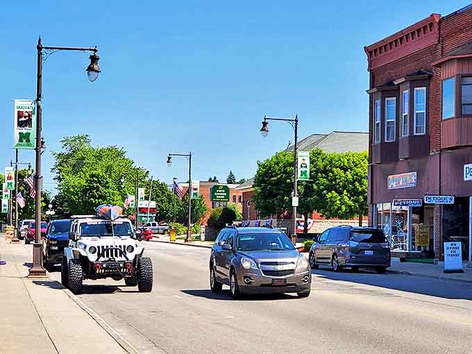 Manistique's bright red lighthouse stands at the end of a stone pier, guiding ships and creating perfect photo opportunities for visitors.