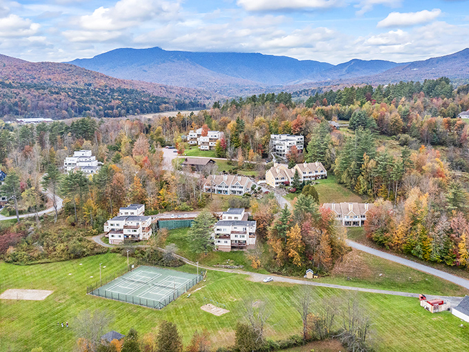 An aerial view revealing Stowe's perfect nestling among autumn-painted mountains &ndash; nature's own color therapy session.