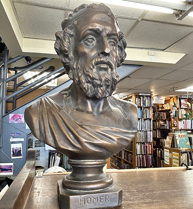 Homer watches over browsing bookworms with bronze dignity, a fitting guardian for this temple of stories both ancient and modern.