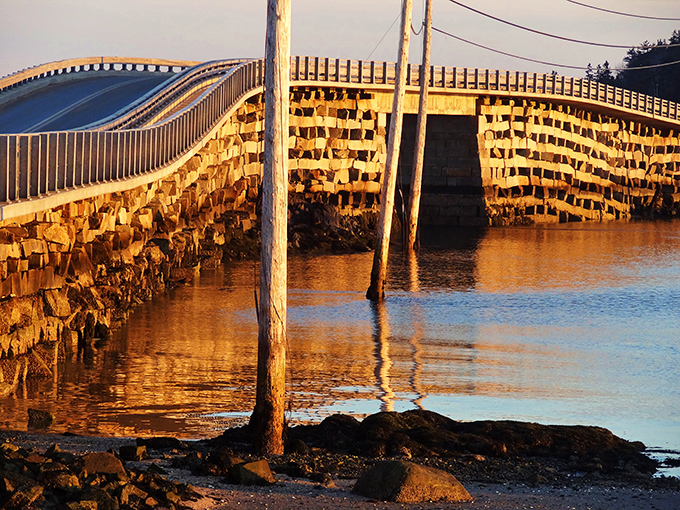 Sunset casts golden light on the granite blocks, transforming this functional structure into a work of natural art.