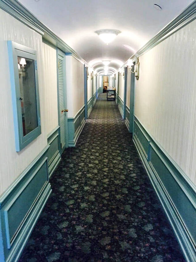 This hallway could tell a thousand stories &ndash; its patterned carpet and soft lighting leading guests to rooms that blend historic charm with modern comforts.