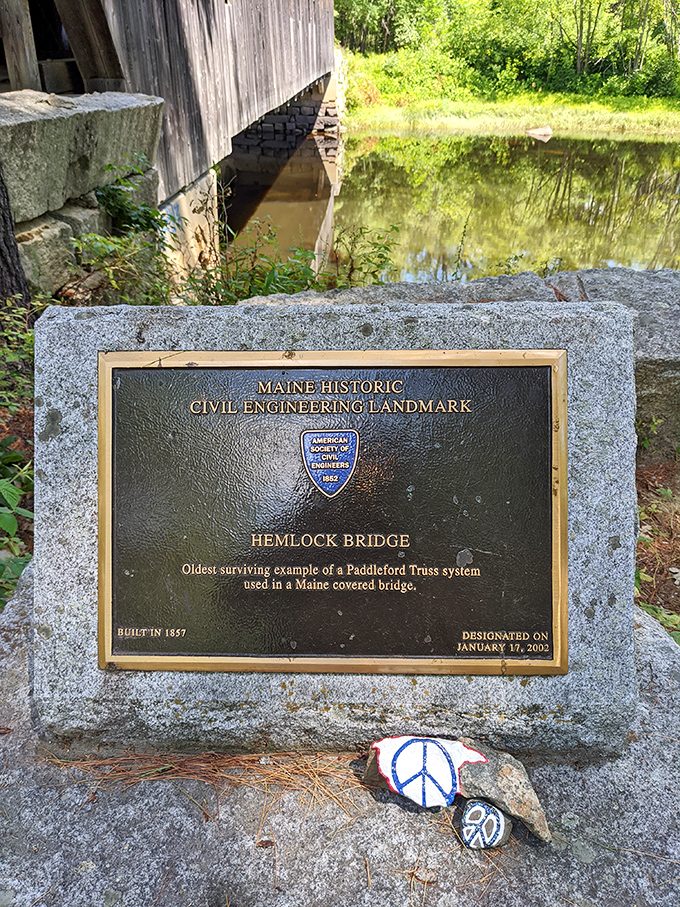 The official marker declares Hemlock Bridge's significance as a Maine Historic Civil Engineering Landmark, recognized for its Paddleford truss design.