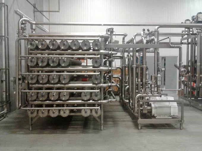 Inside the production facility, where stainless steel equipment transforms ordinary milk into extraordinary cheese.