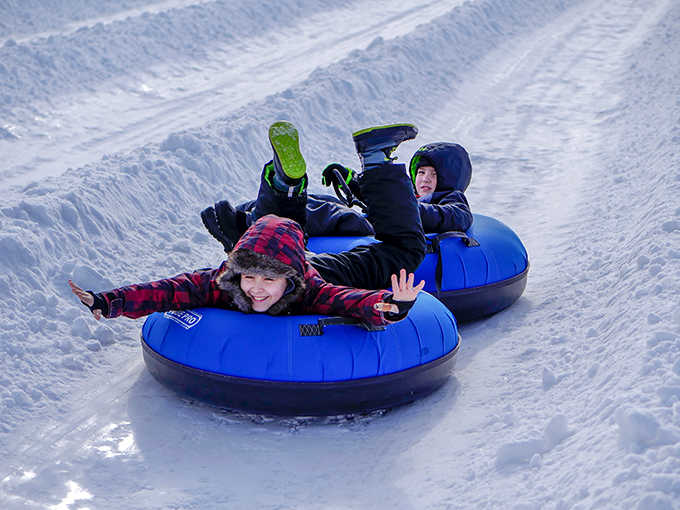 Kids snow tubing: Pure, unfiltered joy captured in motion &ndash; the kind of happiness that makes adults secretly wish they could trade places.
