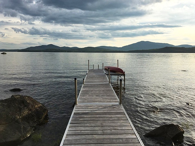 A wooden dock reaches into tranquil waters, inviting contemplation and serving as the perfect launch point for morning swims.