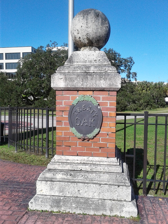 The park's entrance monument stands sentinel, marking the threshold between everyday life and botanical wonderland.