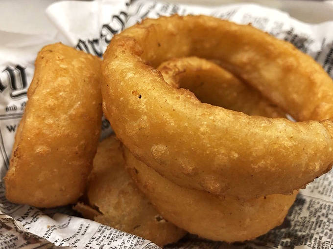 Golden-battered onion rings with that perfect crunch-to-sweetness ratio &ndash; the unsung heroes of the appetizer section.