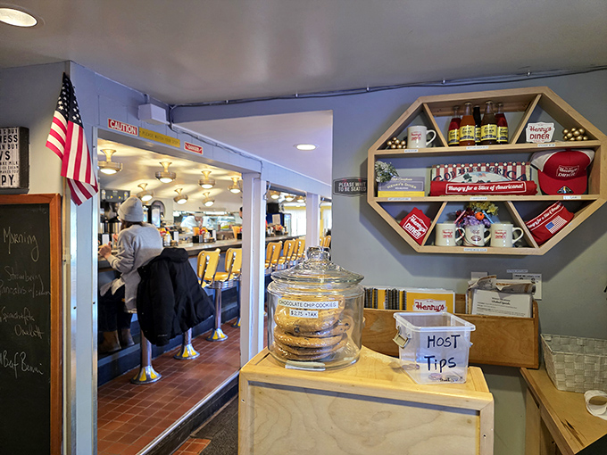 Henry's merchandise display and host station&mdash;the gateway to vinyl booth paradise where hungry patrons wait their turn for diner magic.