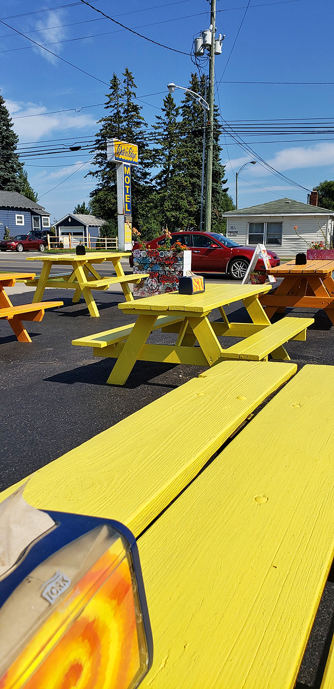 Sunshine-yellow picnic tables create an instant mood boost in the outdoor dining area, perfect for enjoying your meal on beautiful Michigan days.