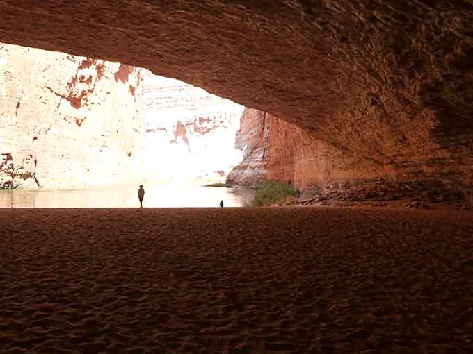 Inside the cave, the sandy floor and soaring ceiling create a space that feels both intimate and impossibly vast at the same time.